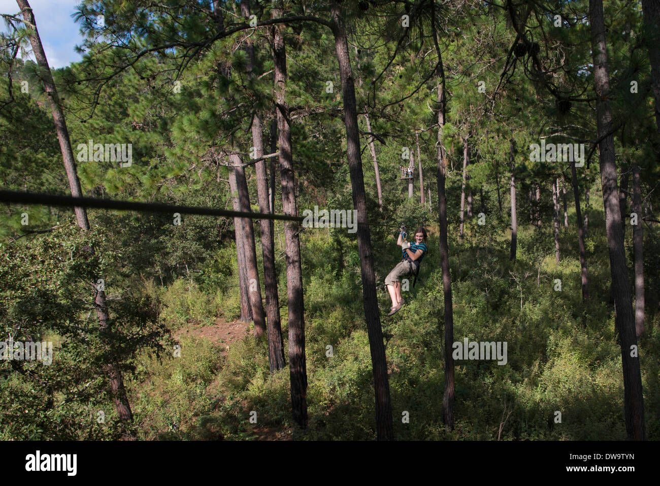 Girl riding a zip line in a forest Copan Copan Ruinas Copan Department ...