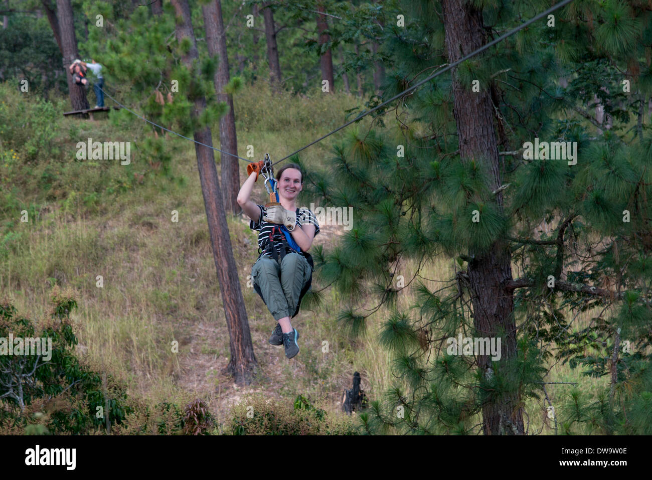 Girl riding a zip line in a forest Copan Copan Ruinas Copan Department ...