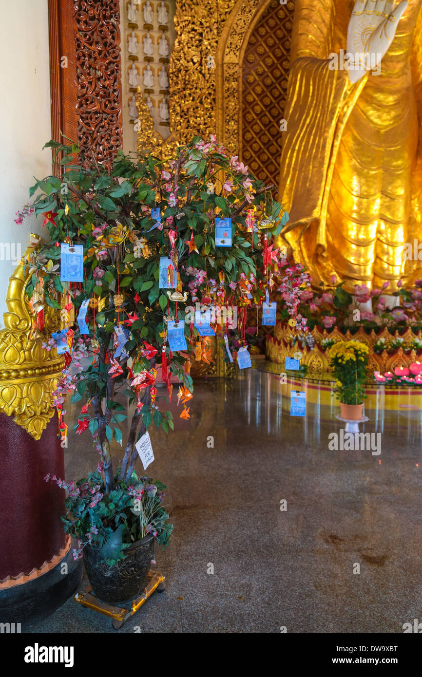 Money tree full of devotee donations inside the Dhammikarama, a burmese ...