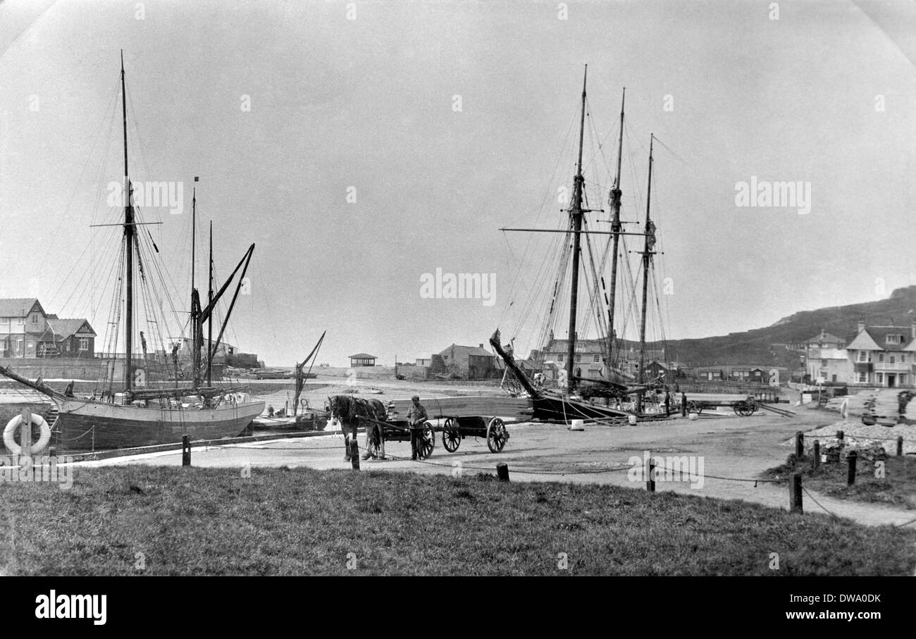 West Bay. Two sailing ships unloading goods in West Bay harbour. Circa ...