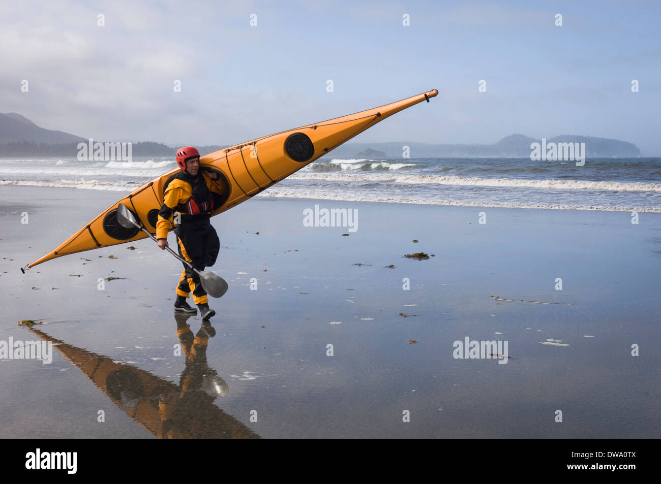 Man carrying kayak on Hobuck Beach, Makah Bay, Washington, USA Stock ...
