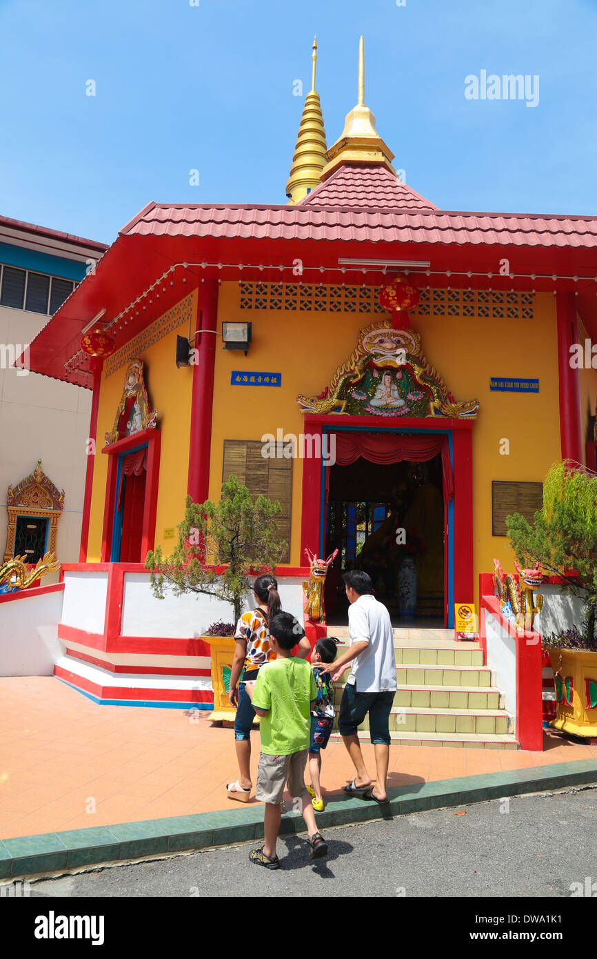 Family visiting a traditional thai temple structure at chayamangalaram ...