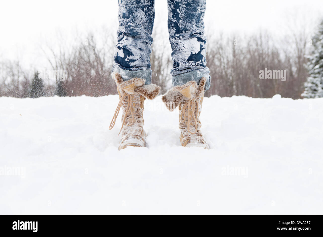 Close up of mid adult womans legs covered in snow Stock Photo - Alamy