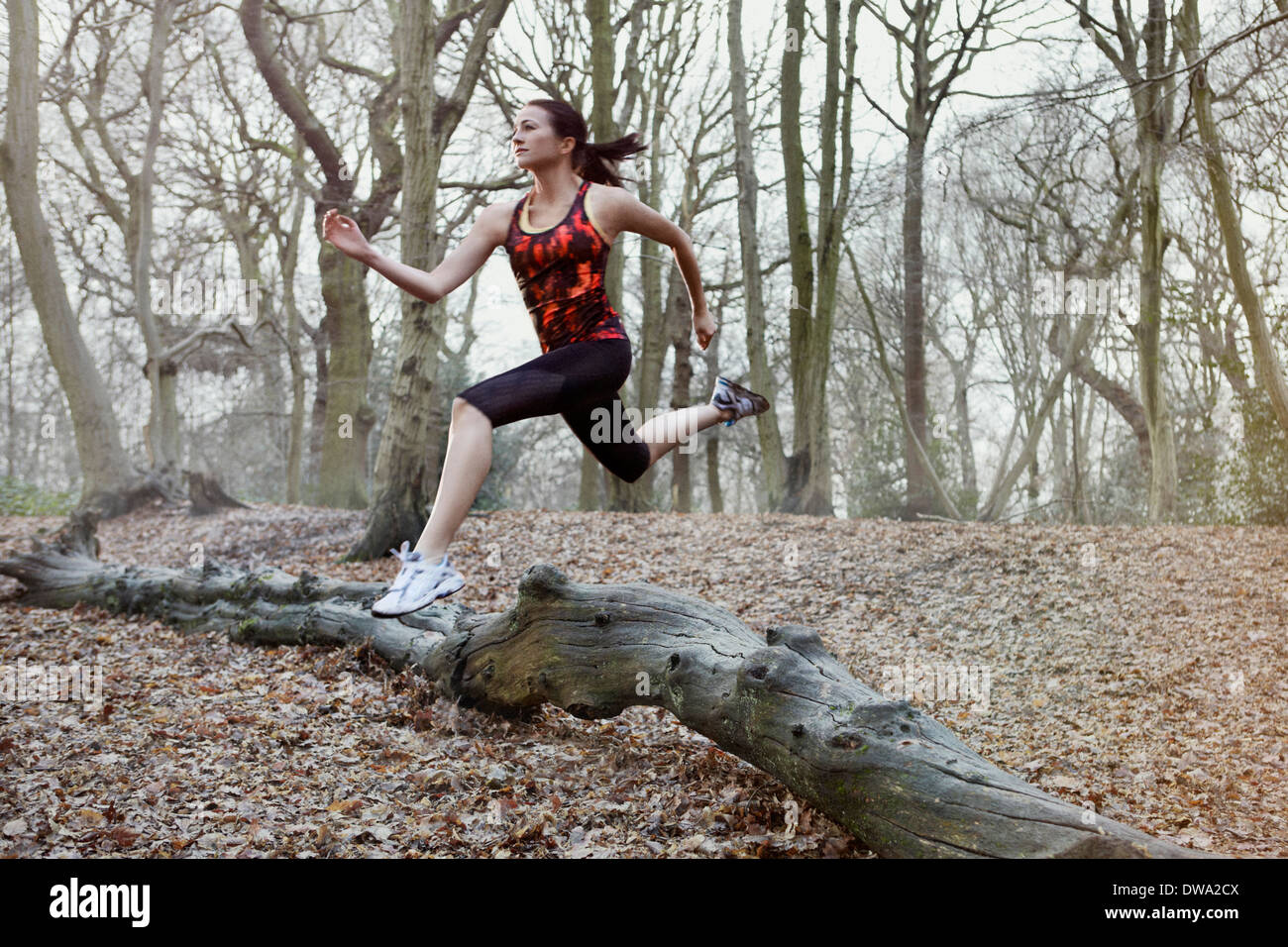 Young woman running in forest hi-res stock photography and images - Alamy