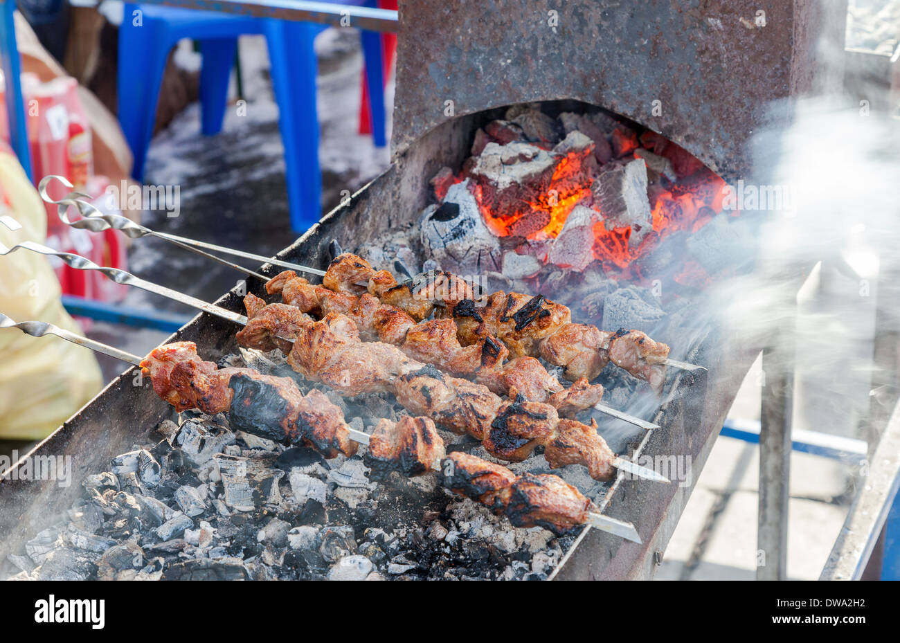Preparation of meat slices in sauce on fire Stock Photo - Alamy