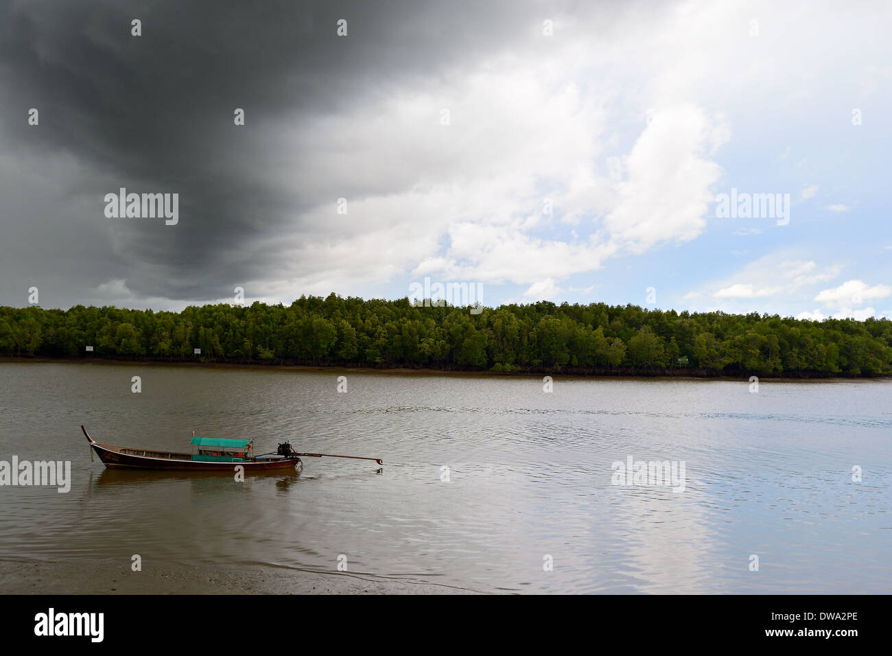 Long tailed boat and villages on Krabi River (Southern Thailand) with ...