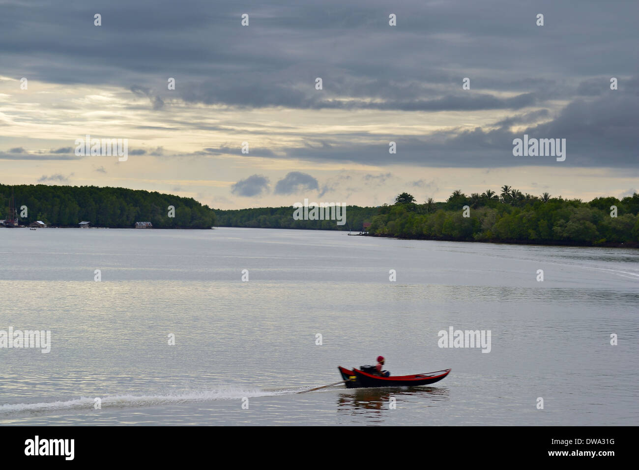 Long tailed boat and villages on Krabi River (Southern Thailand) with ...