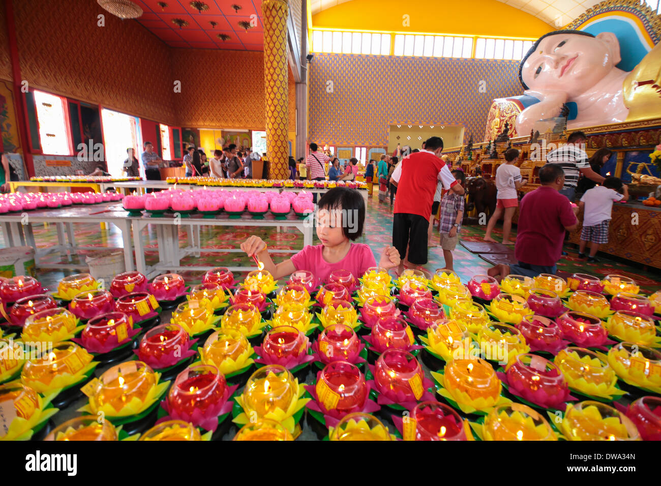 A child lighting up a prayer lantern in chayamangalaram, a famous ...