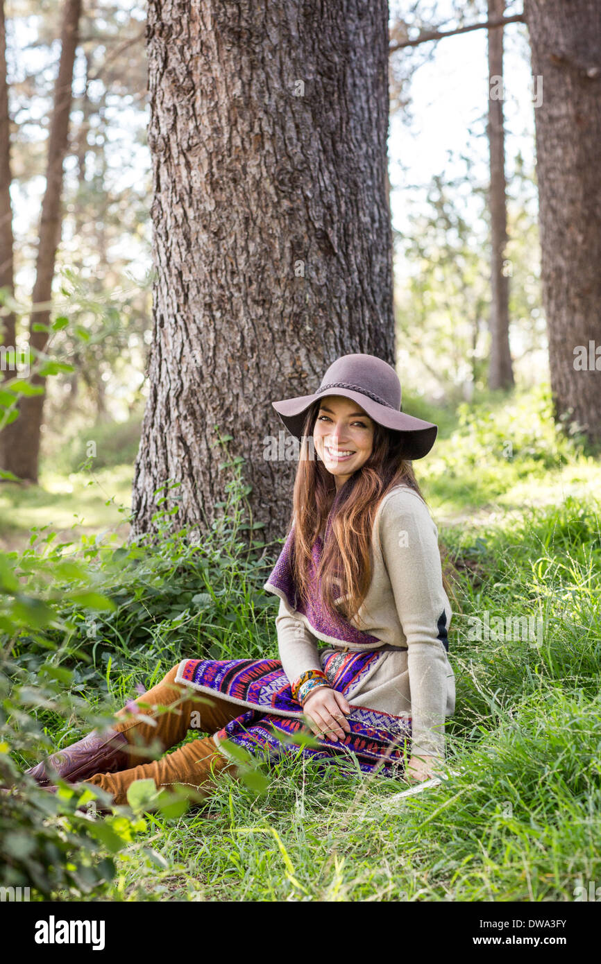 Portrait of young woman in forest, smiling Stock Photo - Alamy