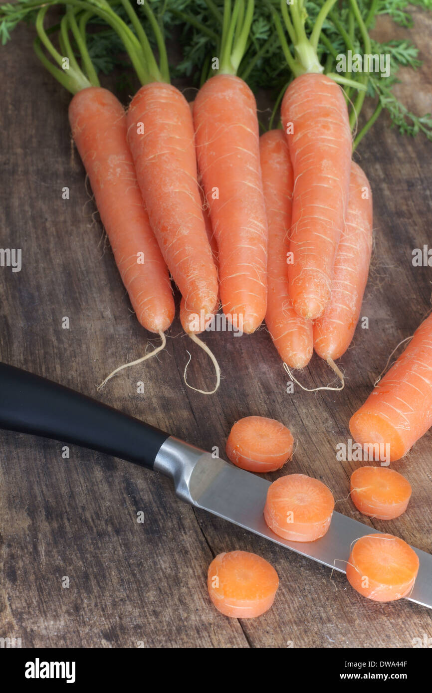 Cutting up freshly picked carrots Stock Photo - Alamy