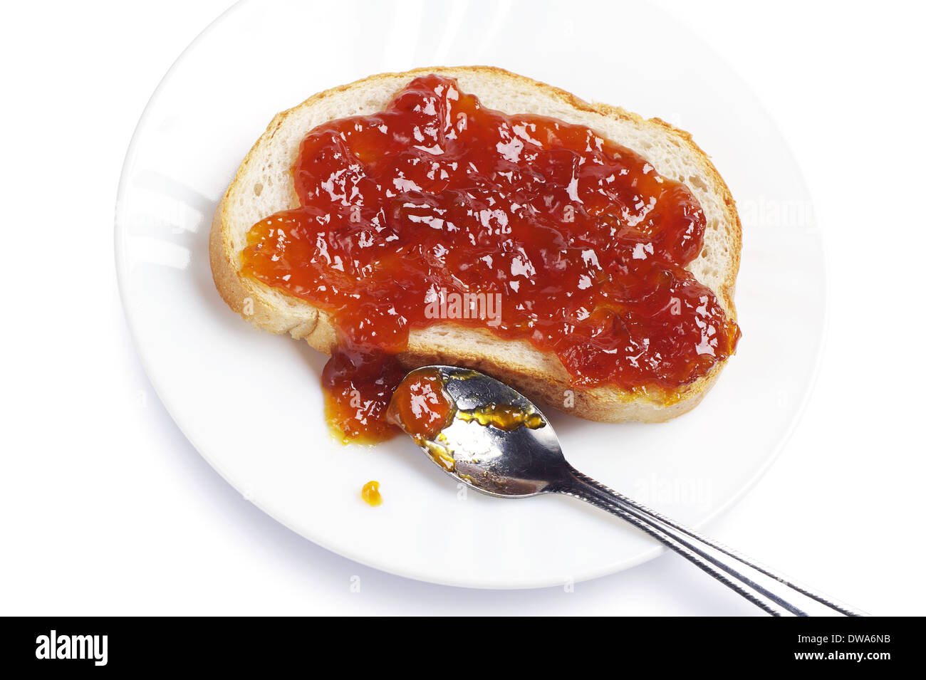 Bread with jam in plate on white background Stock Photo - Alamy