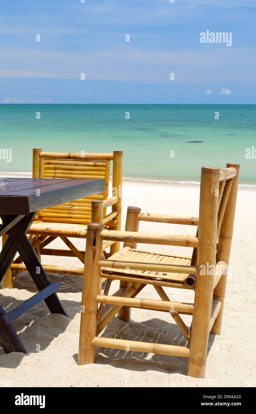 Chairs and table on the coral sandy beach with turquoise transparent ...