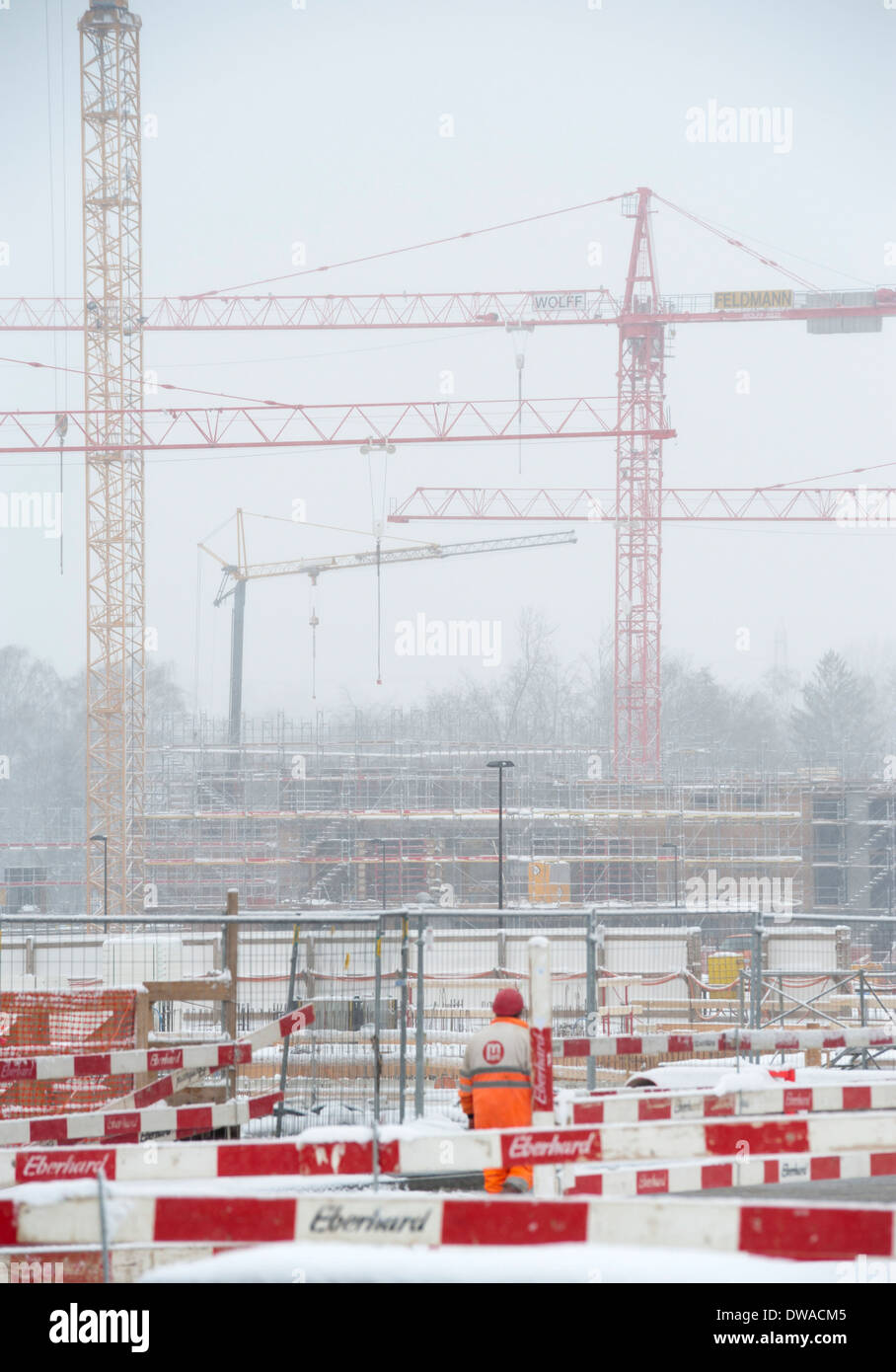 Construction workers and building activity on a snowed winter ...