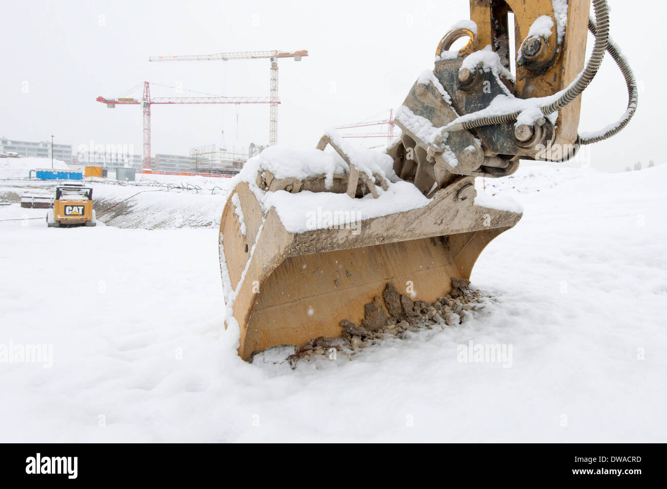 Stopped construction building activity on a snowed winter construction ...