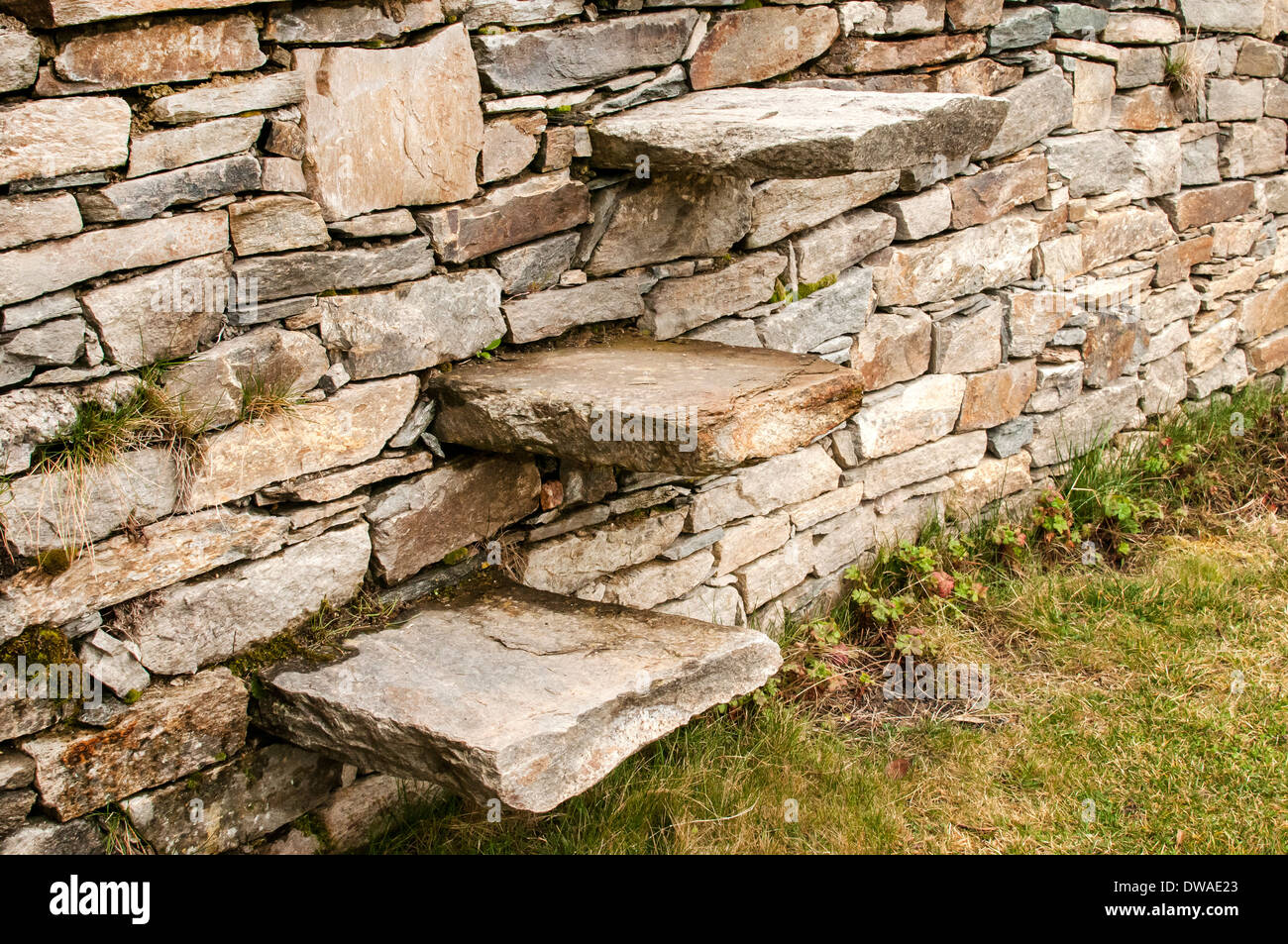 Stone steps into stonewall Stock Photo - Alamy