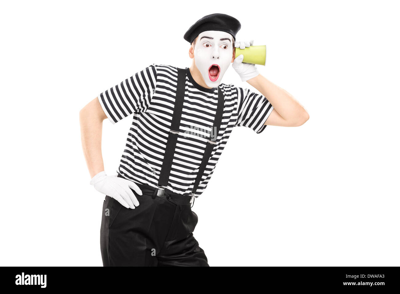 Male mime artist listening through a wall with a cup Stock Photo - Alamy