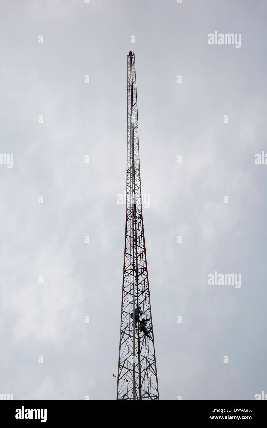 Man climbing communications tower hi-res stock photography and images ...