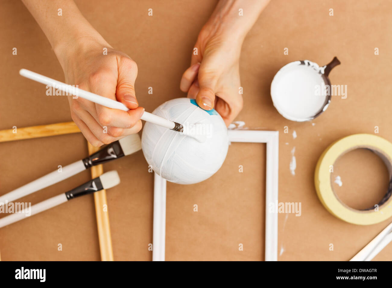 Painter painting a sphere, close-up Stock Photo - Alamy