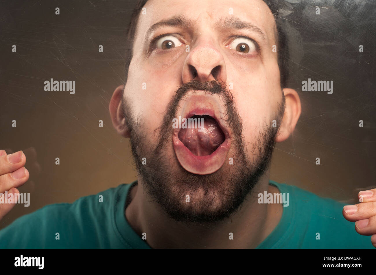 Funny Faces - Man Blowing Against the Glass Surface Stock Photo - Alamy