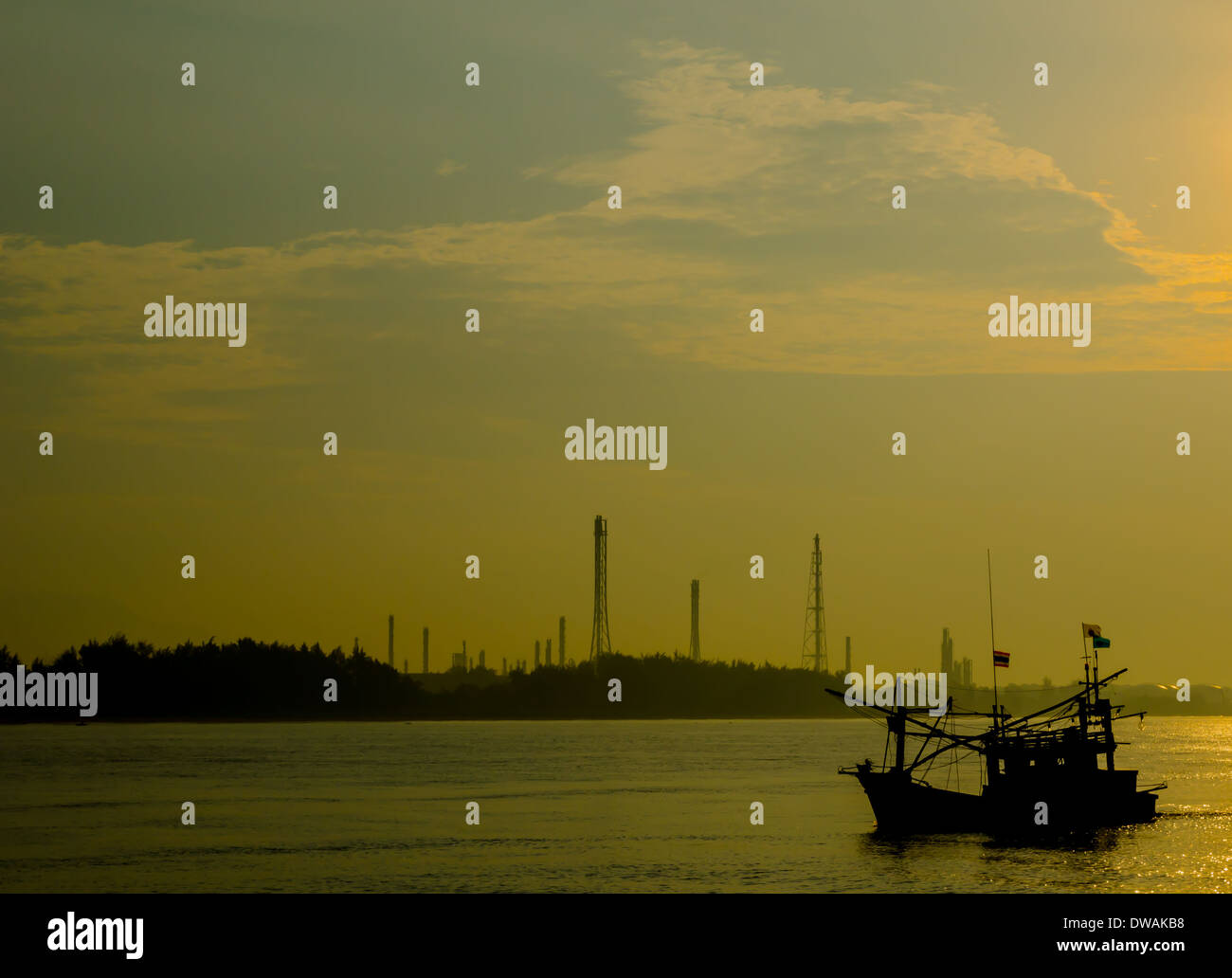 Refinery heavy industrial effect with lifestyle of small boat fisherman ...