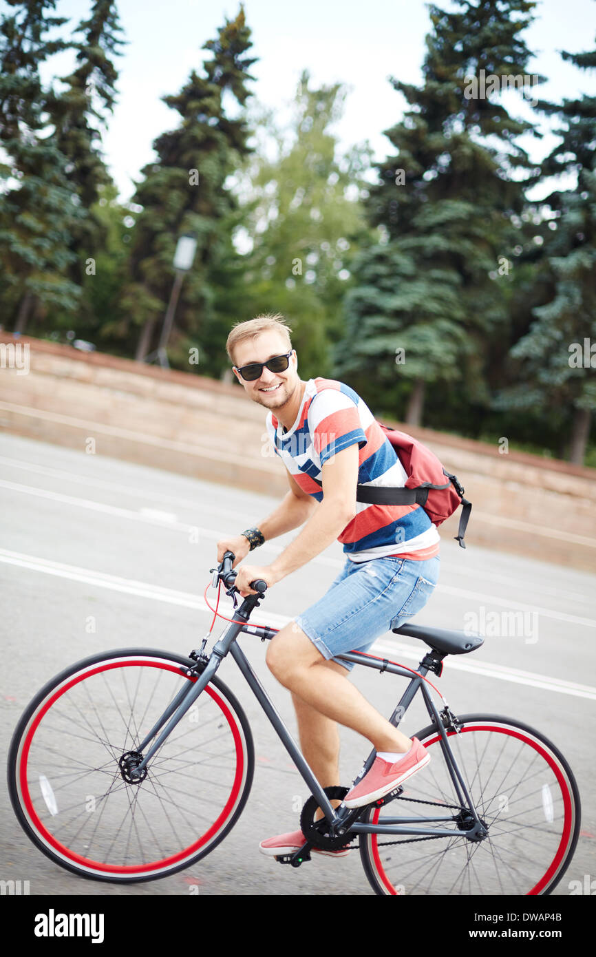 Portrait happy guy riding bicycle hi-res stock photography and images ...