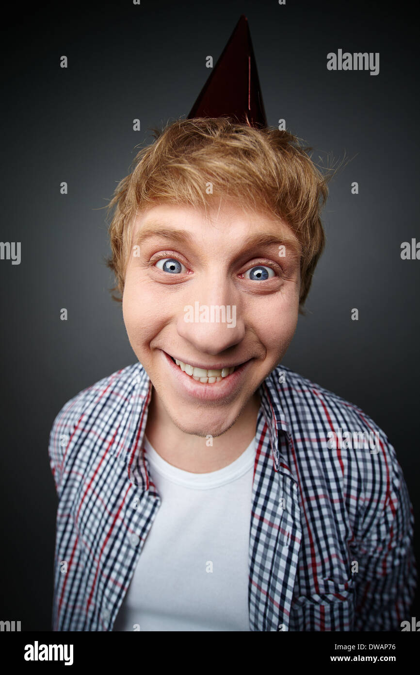 Cheerful guy in a cone cap being ready for fool’s day celebration Stock ...