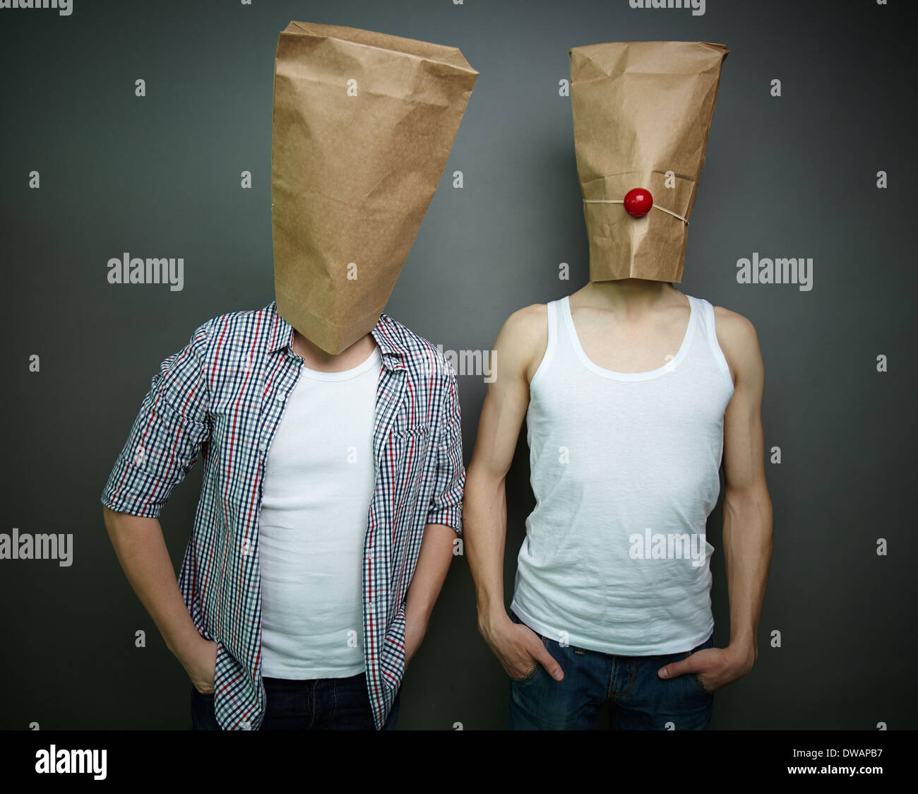 Two guys standing in front of camera in paper bags celebrating fool’s ...