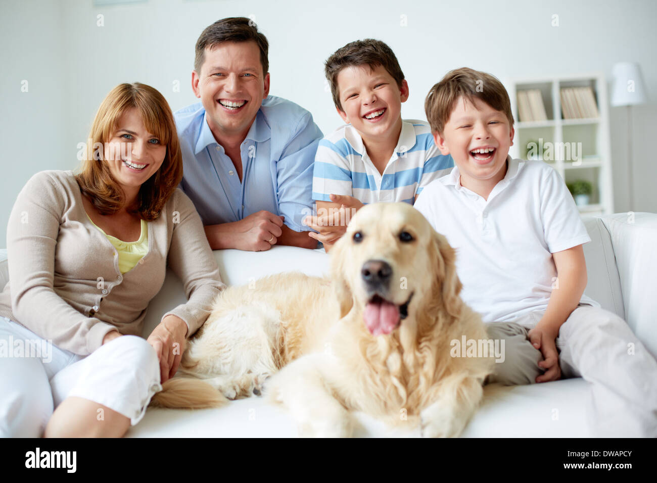 Portrait of happy family with their pet having good time at home Stock ...