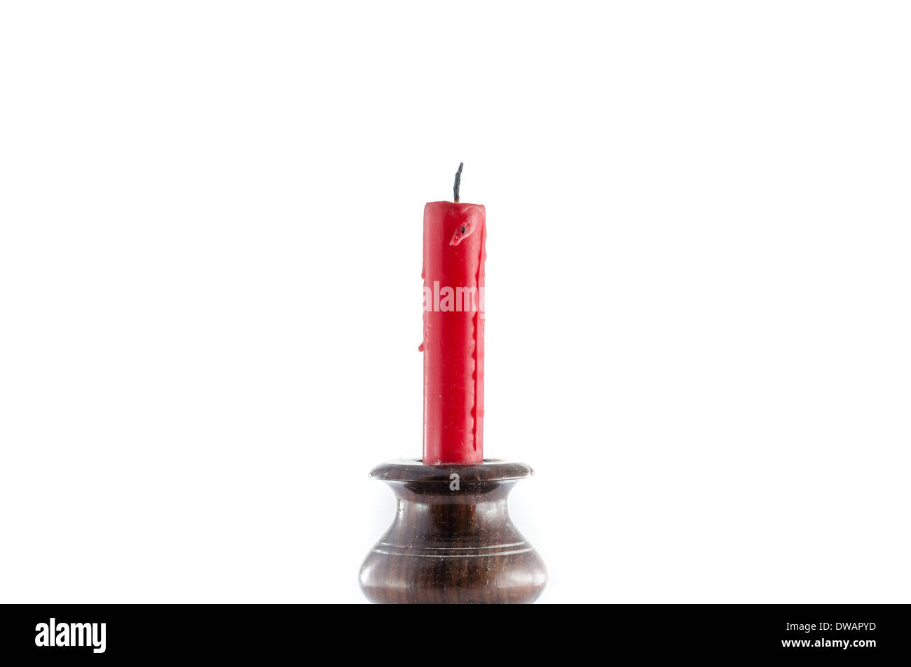red candle wood candlestick on the white background Stock Photo - Alamy