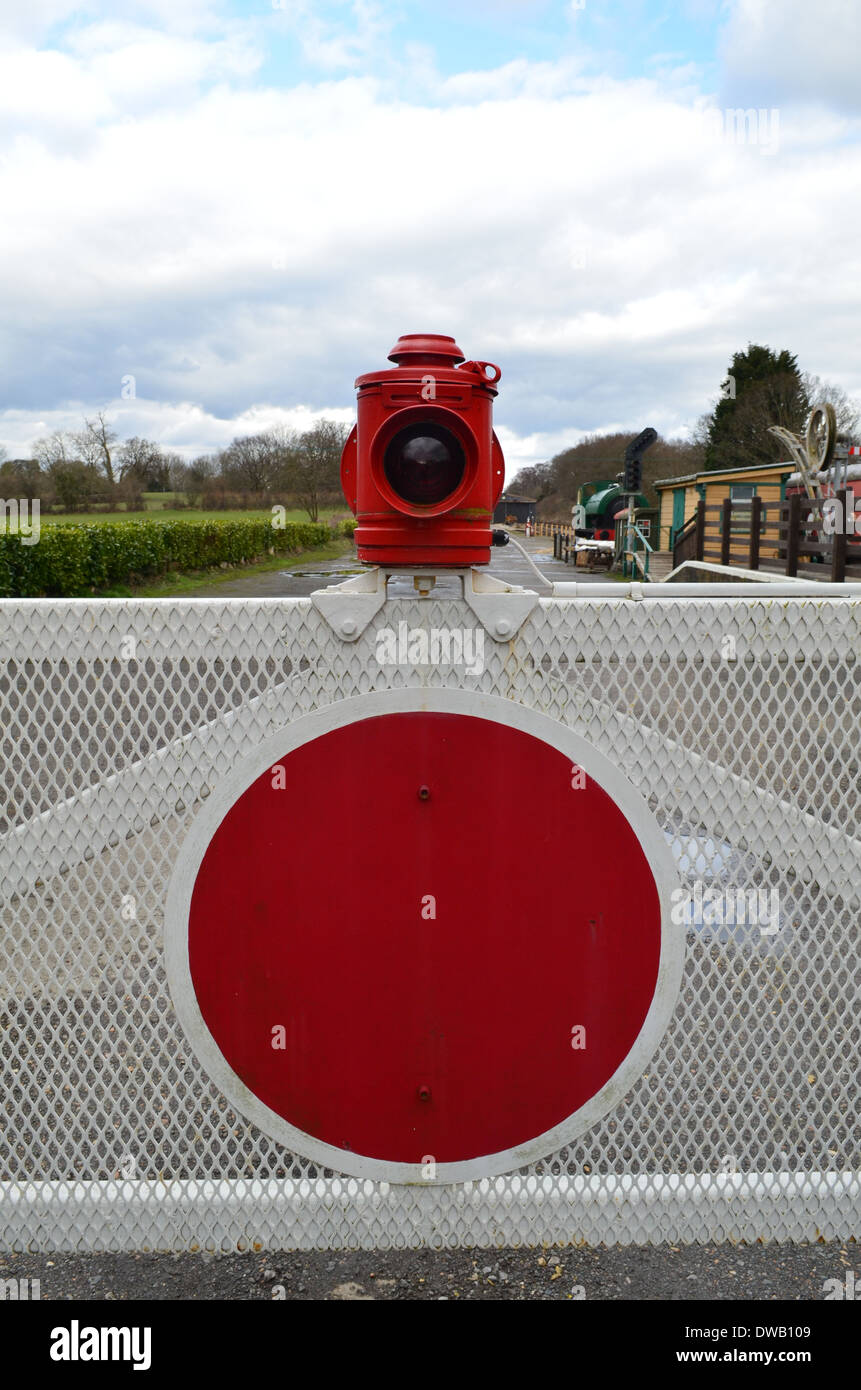 Railway crossing gate with safety stop lamp Stock Photo - Alamy