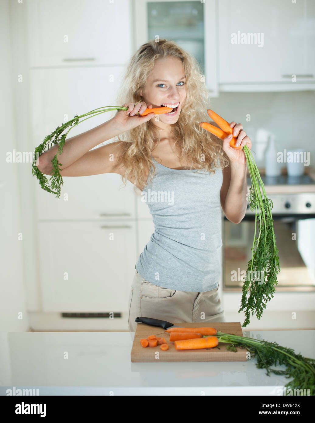 Woman eating carrot hi-res stock photography and images - Alamy