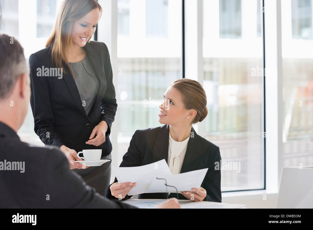 Business people with paperwork during coffee break Stock Photo - Alamy