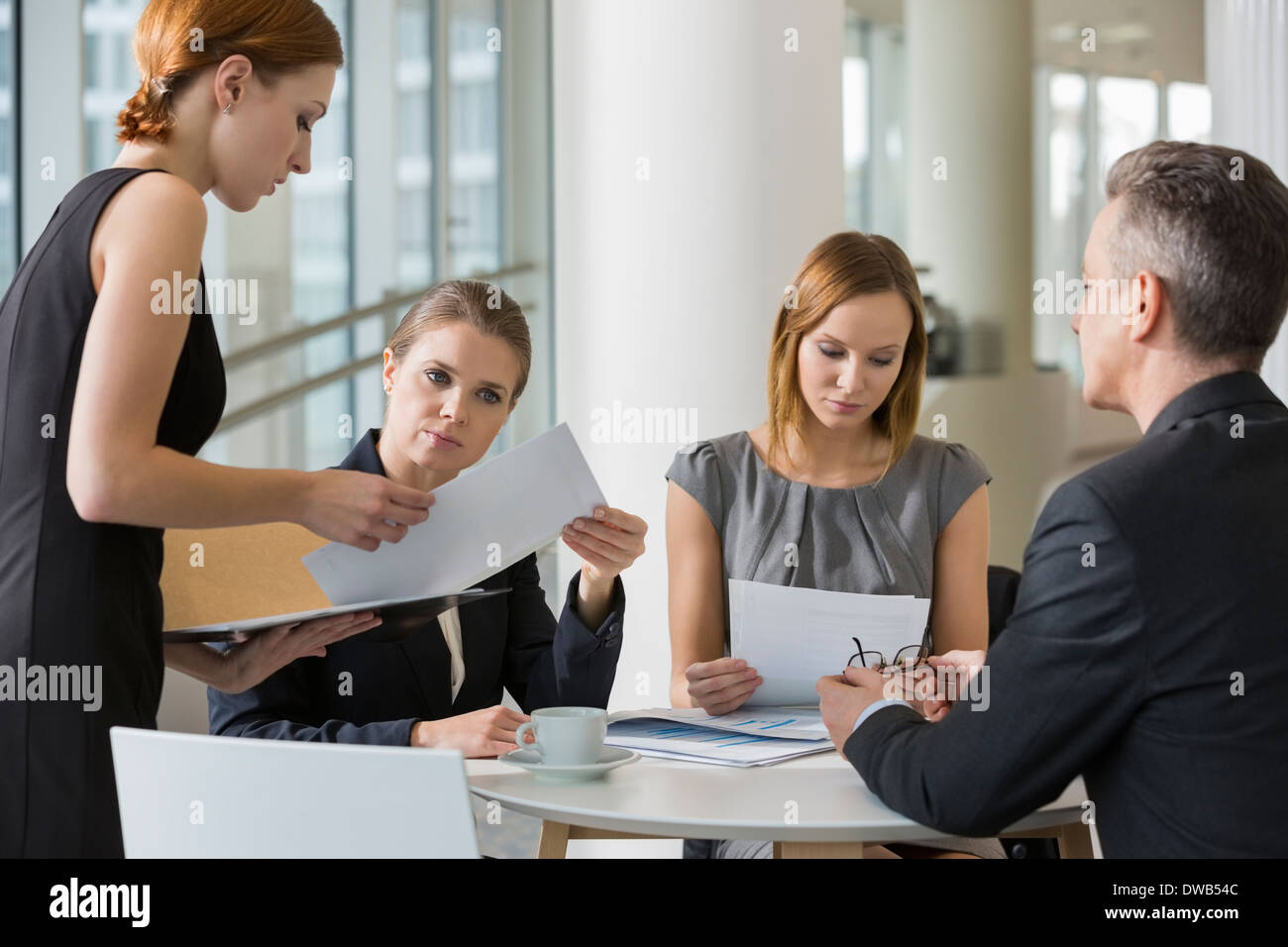 Business people doing paperwork in office cafeteria Stock Photo - Alamy