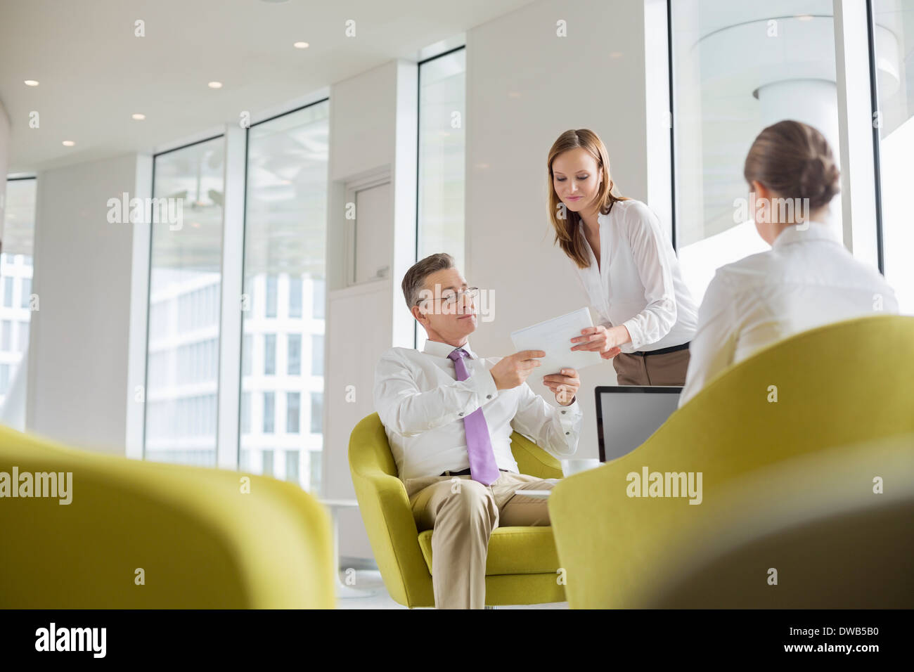 Business people working in office lobby Stock Photo - Alamy