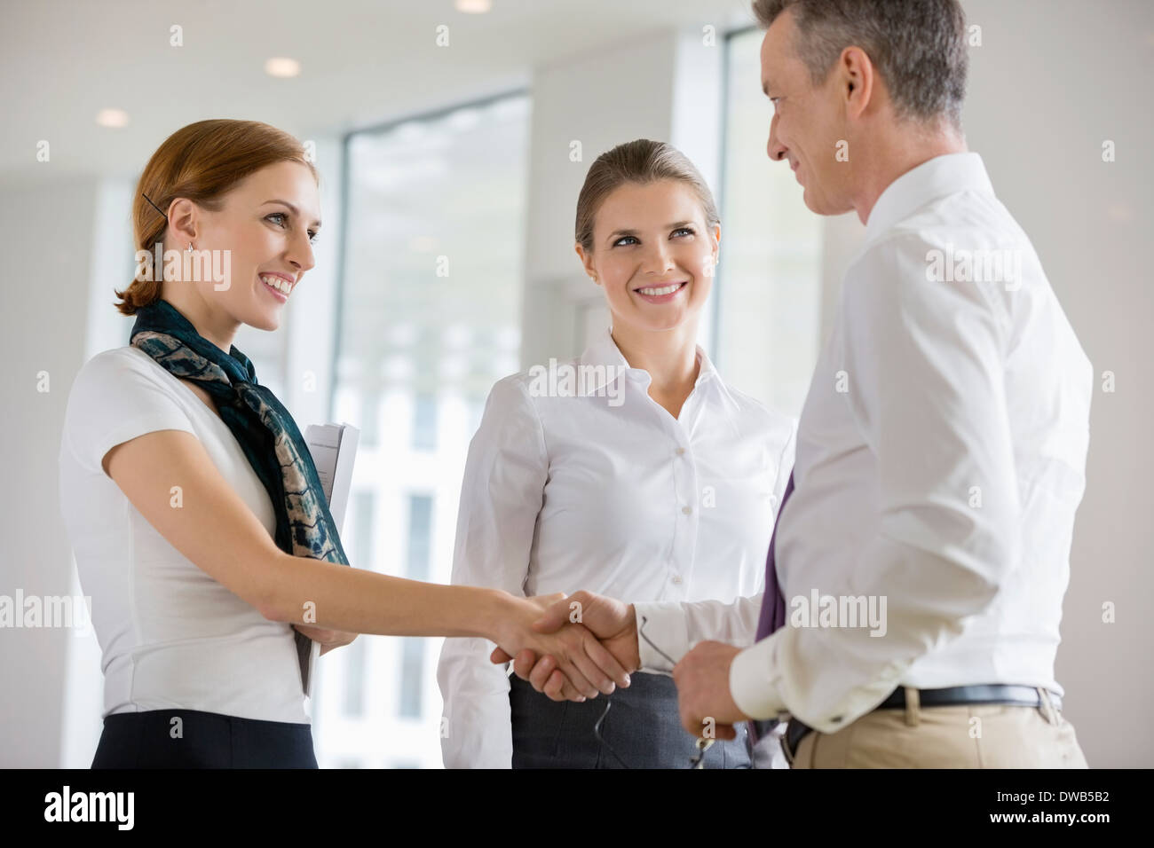 Business woman shaking hands office hi-res stock photography and images ...