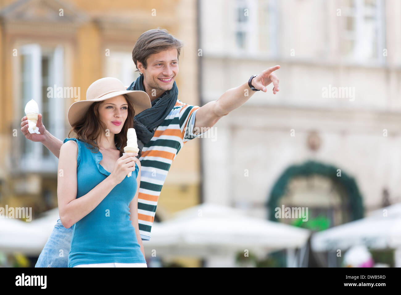 Young couple enjoying ice cream cones during vacation Stock Photo - Alamy