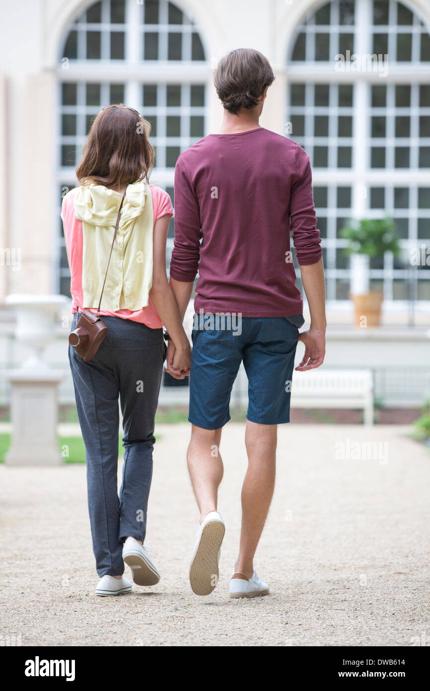 Back view young couple walking hi-res stock photography and images - Alamy