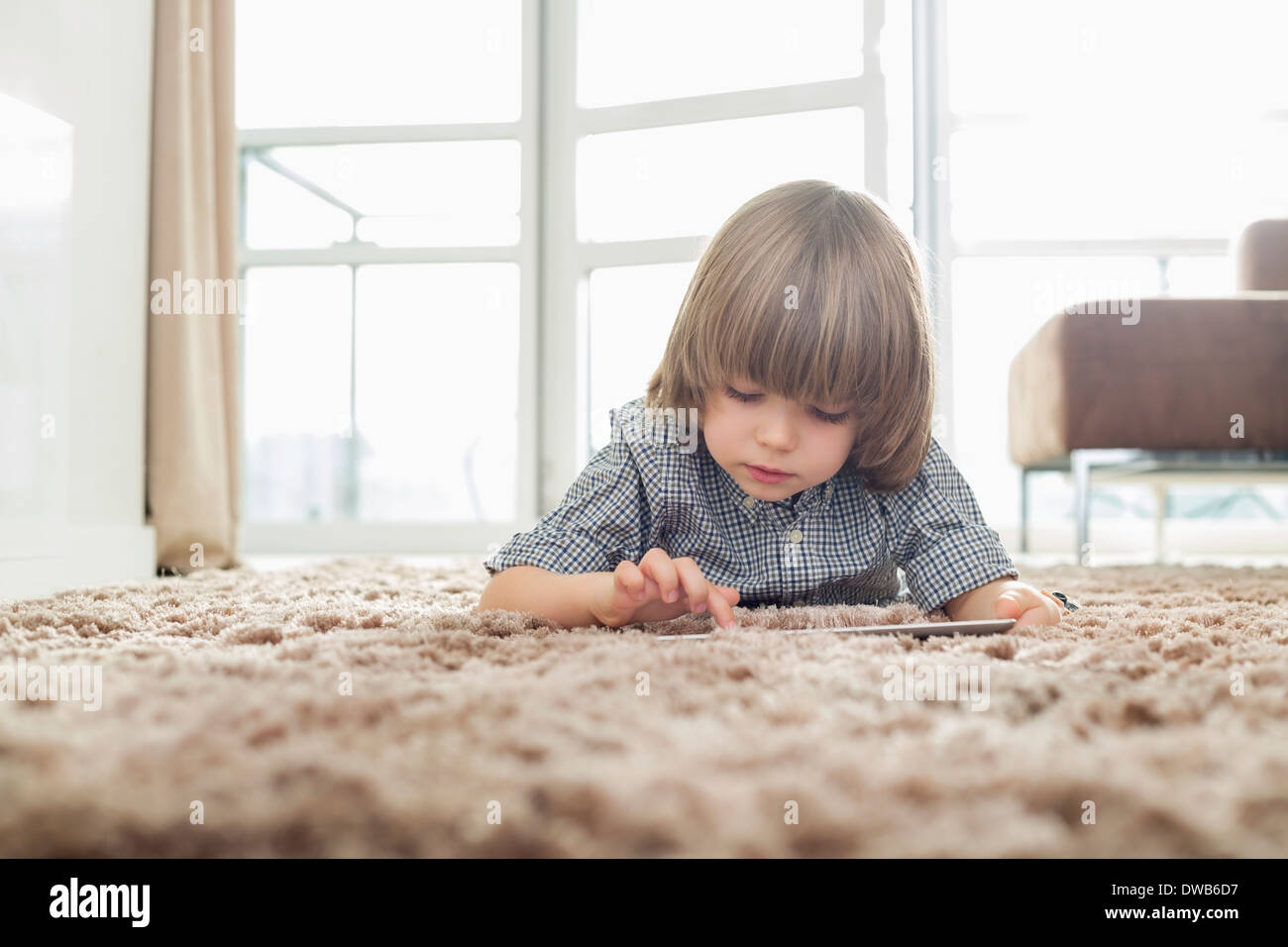 Boy lying on rug using hi-res stock photography and images - Alamy