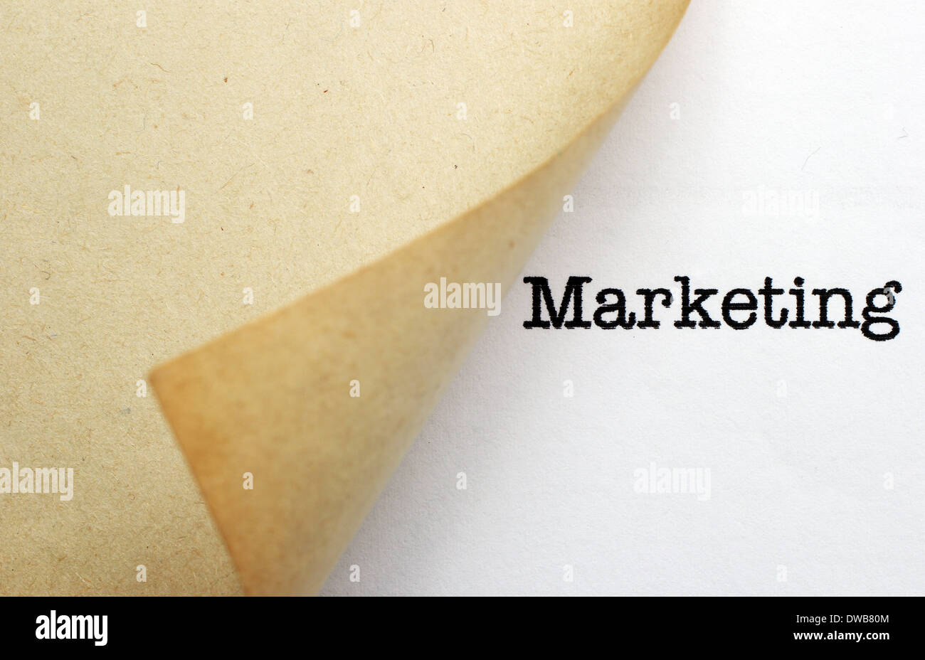 Marketing text behind paper Stock Photo - Alamy