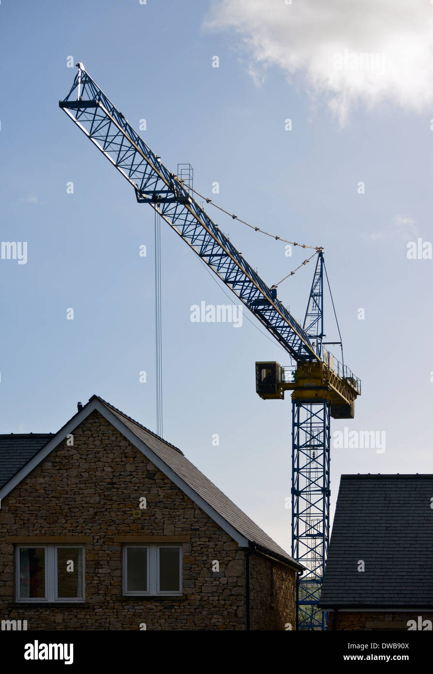 Tower crane on house building site Stock Photo - Alamy