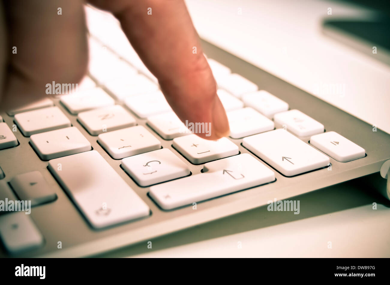 A finger on a white keyboard, ready to press the enter key Stock Photo ...