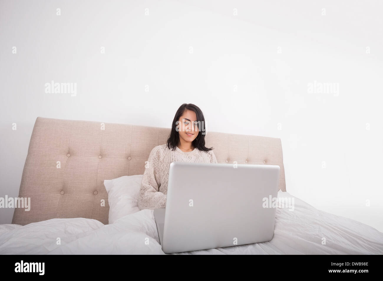 Woman using laptop on bed hi-res stock photography and images - Alamy