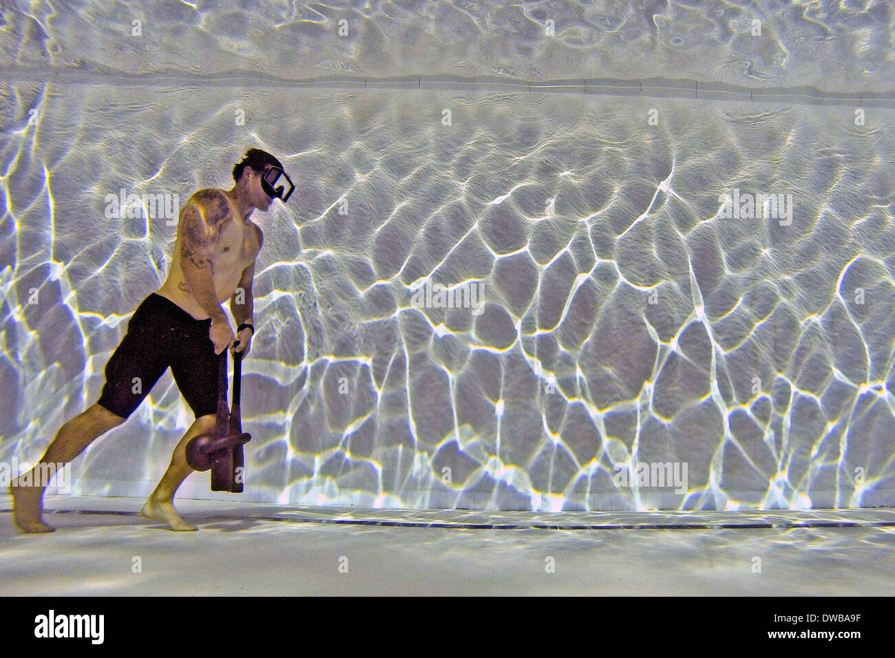 A US Navy search and rescue swimmer performs underwater kettle bell ...