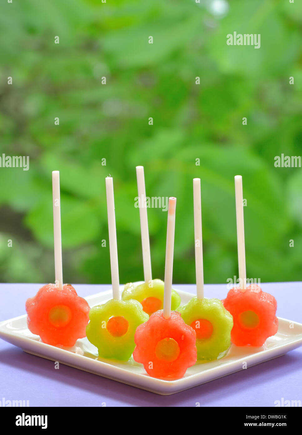 yellow and red watermelon lollipop Stock Photo - Alamy