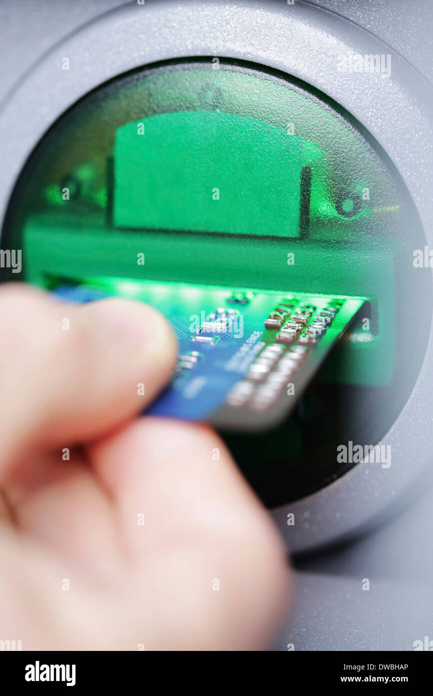 Man pushing credit card at cash dispenser, close-up Stock Photo - Alamy