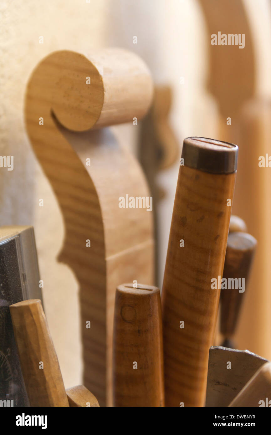 Tools and scroll of a violin in a violin maker's workshop Stock Photo ...
