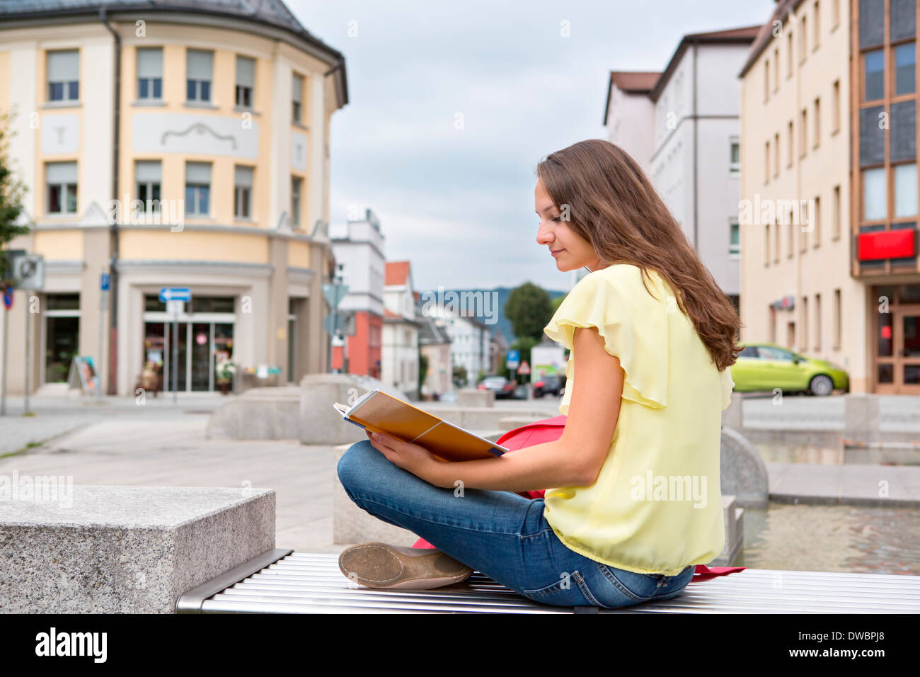 Germany, teenage girl reading a book Stock Photo - Alamy