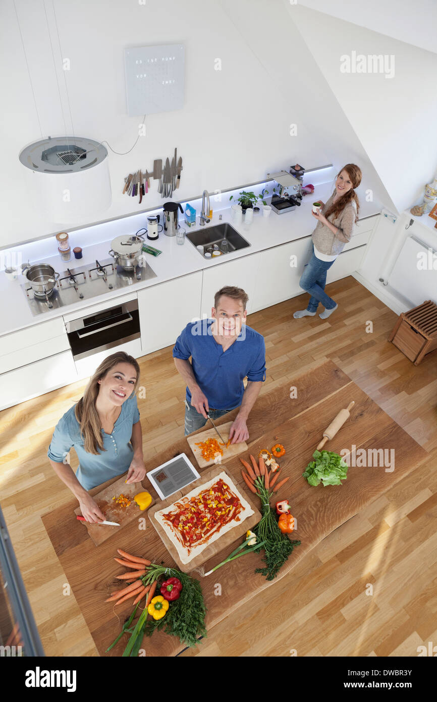 Three friends cooking together, top view Stock Photo - Alamy