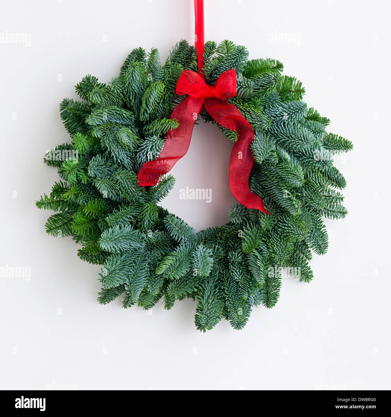 Advent wreath with red ribbon over a bright wall Stock Photo - Alamy