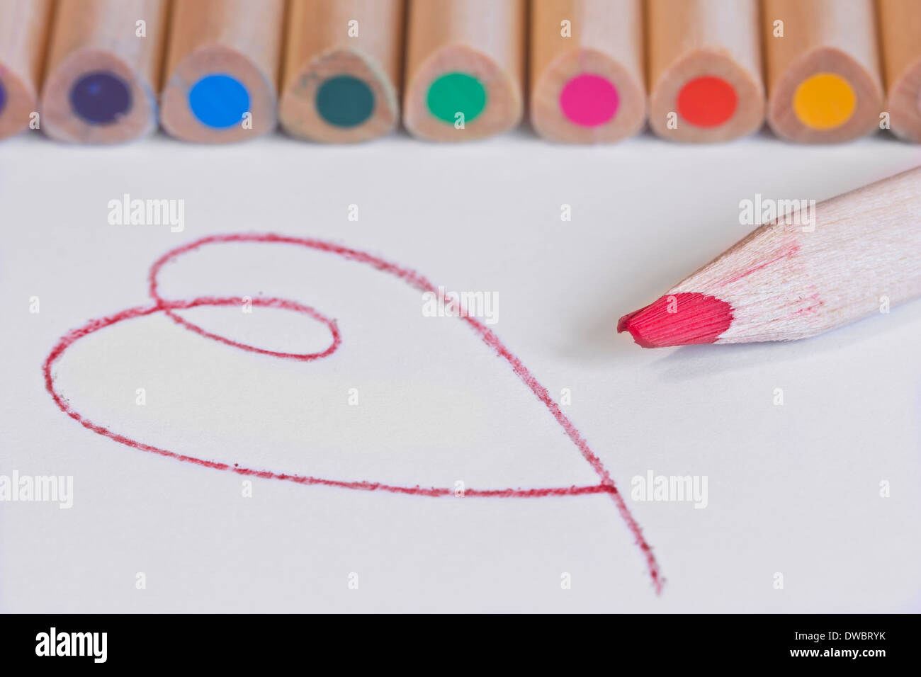 Row of colored pencils and drawn heart Stock Photo - Alamy